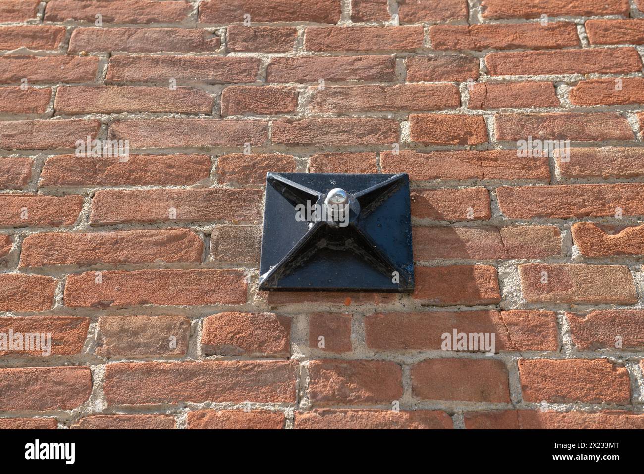 Tie rod on the wall of an exposed brick building with construction ...
