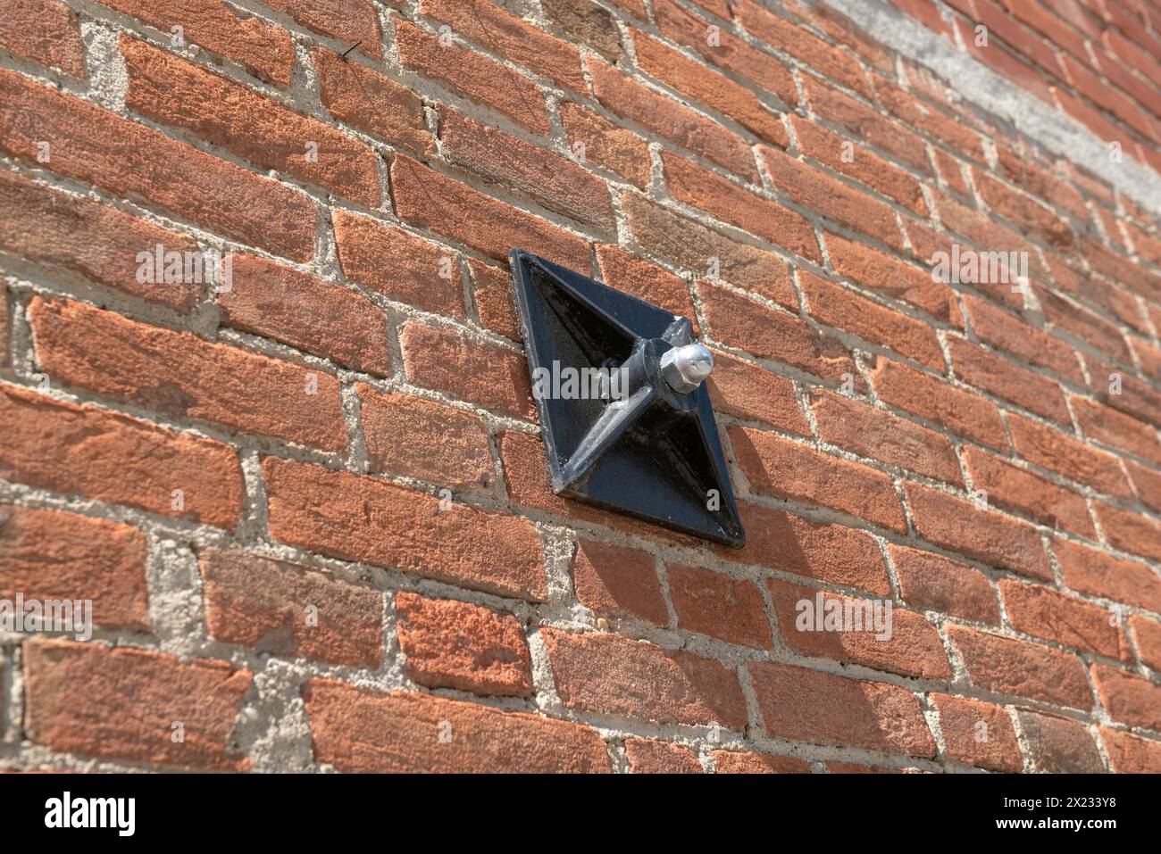 Tie rod on the wall of an exposed brick building with construction ...