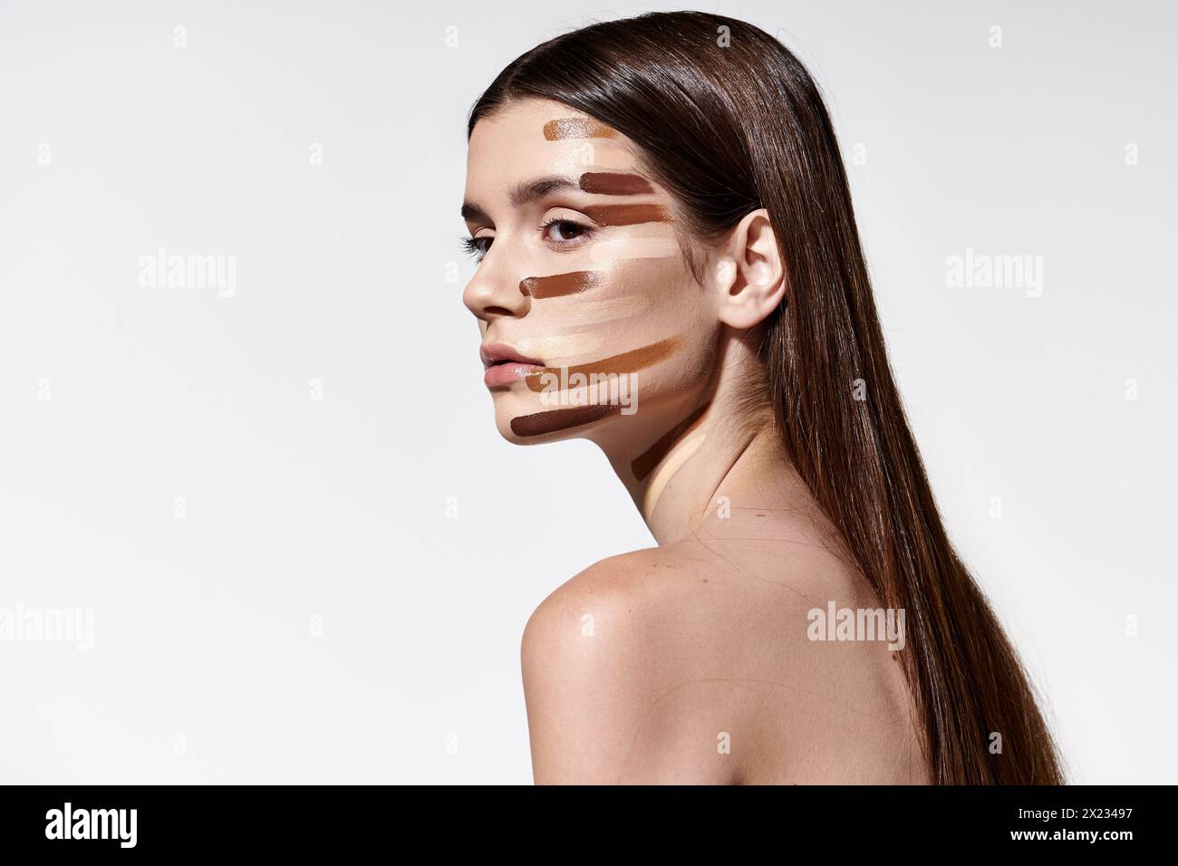 Tasteful young woman adorned with layers of foundation, showcasing ...