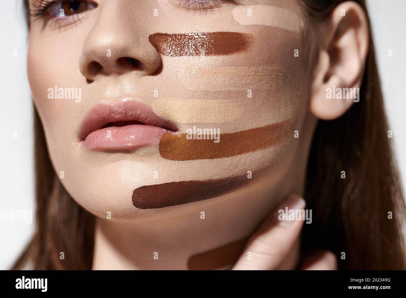 Appealing woman showcases her beauty with makeup on her face, including ...