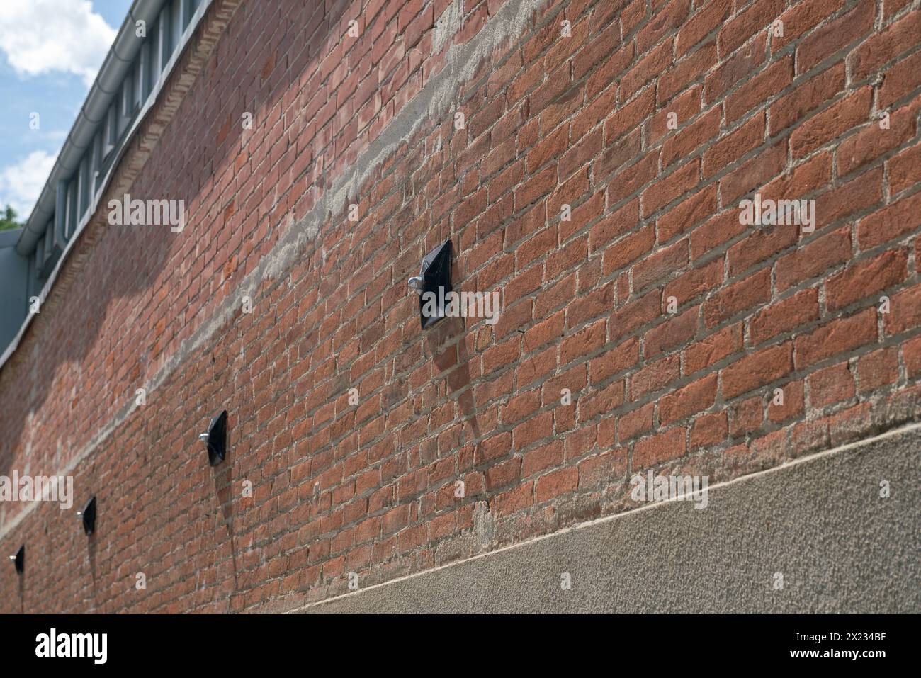 Tie rod on the wall of an exposed brick building with construction ...