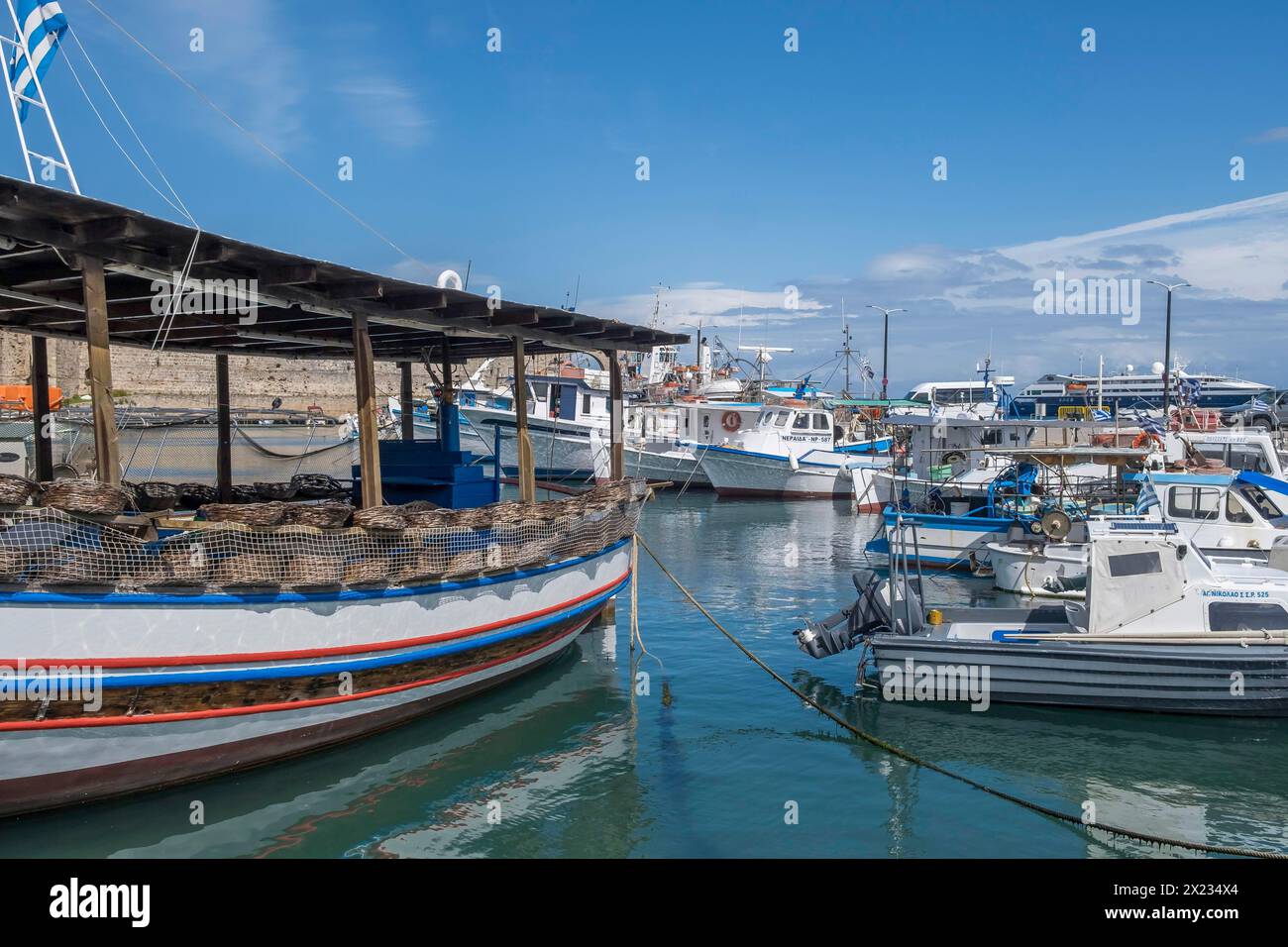 Boats anchoring in Kolona harbour in front of the city wall, Rhodes ...
