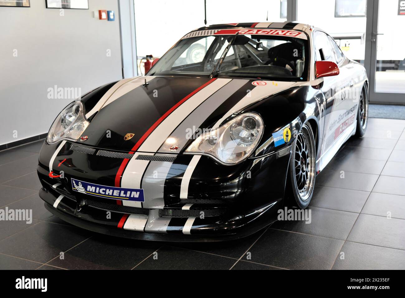A Porsche 911 racing car with advertising livery and Michelin ...