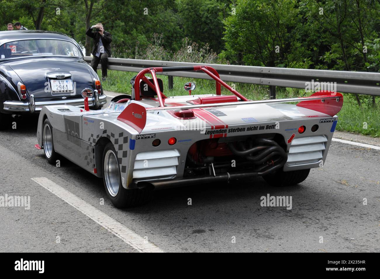 Rear view of a red and white racing car with a large rear wing on a ...