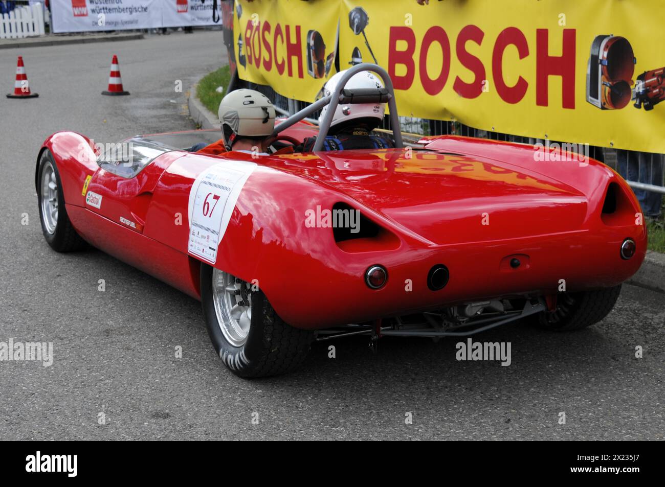 A red open-top racing car with a driver in full gear, SOLITUDE REVIVAL ...