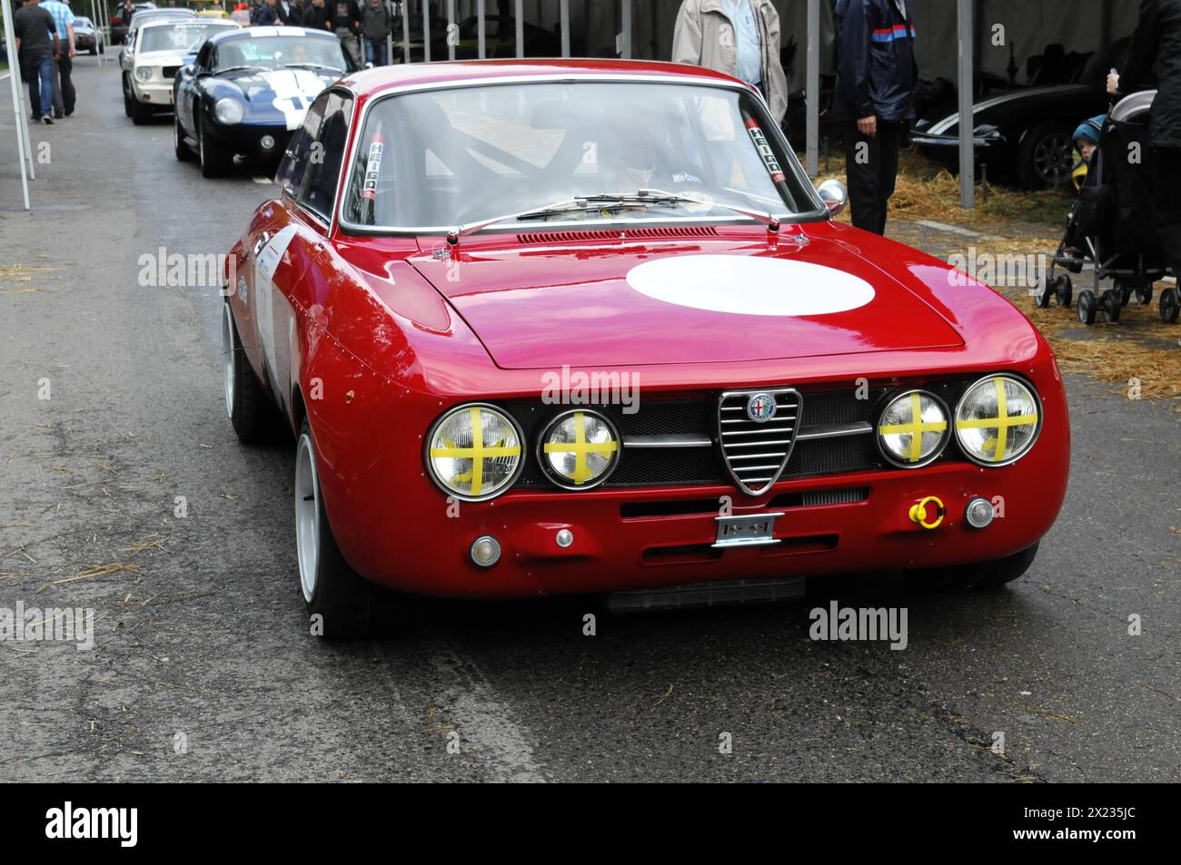 An Alfa Romeo classic car in racing livery with starting number on the ...