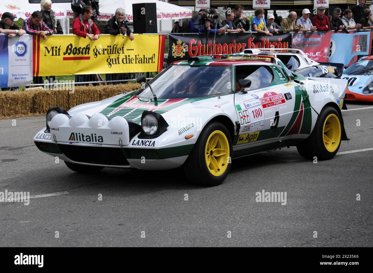 A Lancia Stratos rally car with Alitalia advertising at a racing event ...