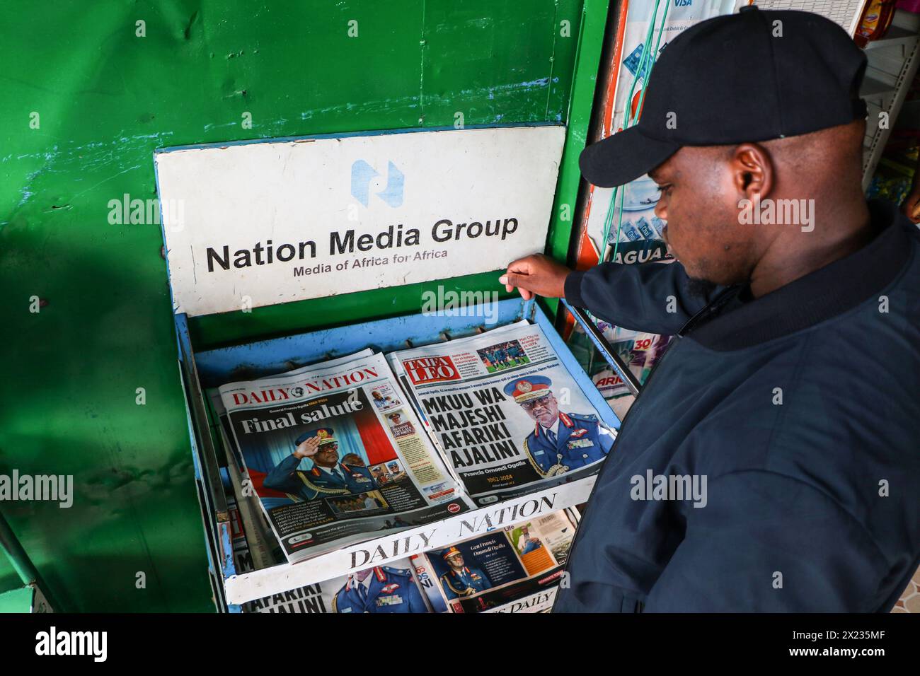 Nakuru, Kenya. 19th Apr, 2024. A man reads Kenyan newspapers featuring ...