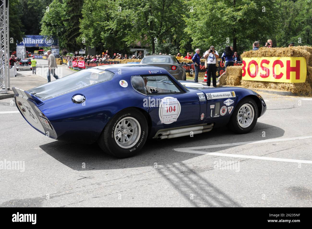 A blue historic racing car with starting number on a race track in ...