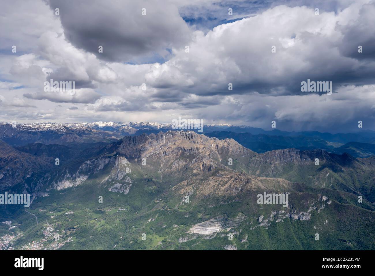 aerial landscape, from a glider plane, with large quarry under steep ...