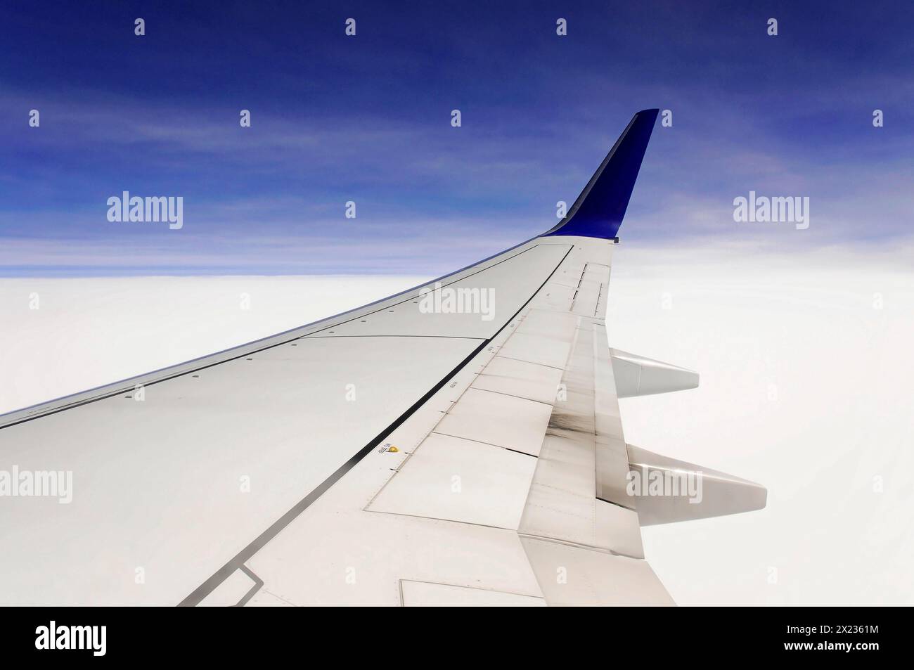 View of aeroplane wings above clouds and under clear sky, AUGUSTO C ...