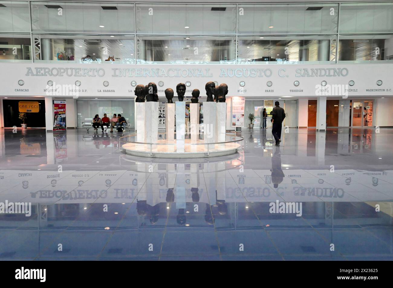 Information board in an airport terminal with names and symbols ...