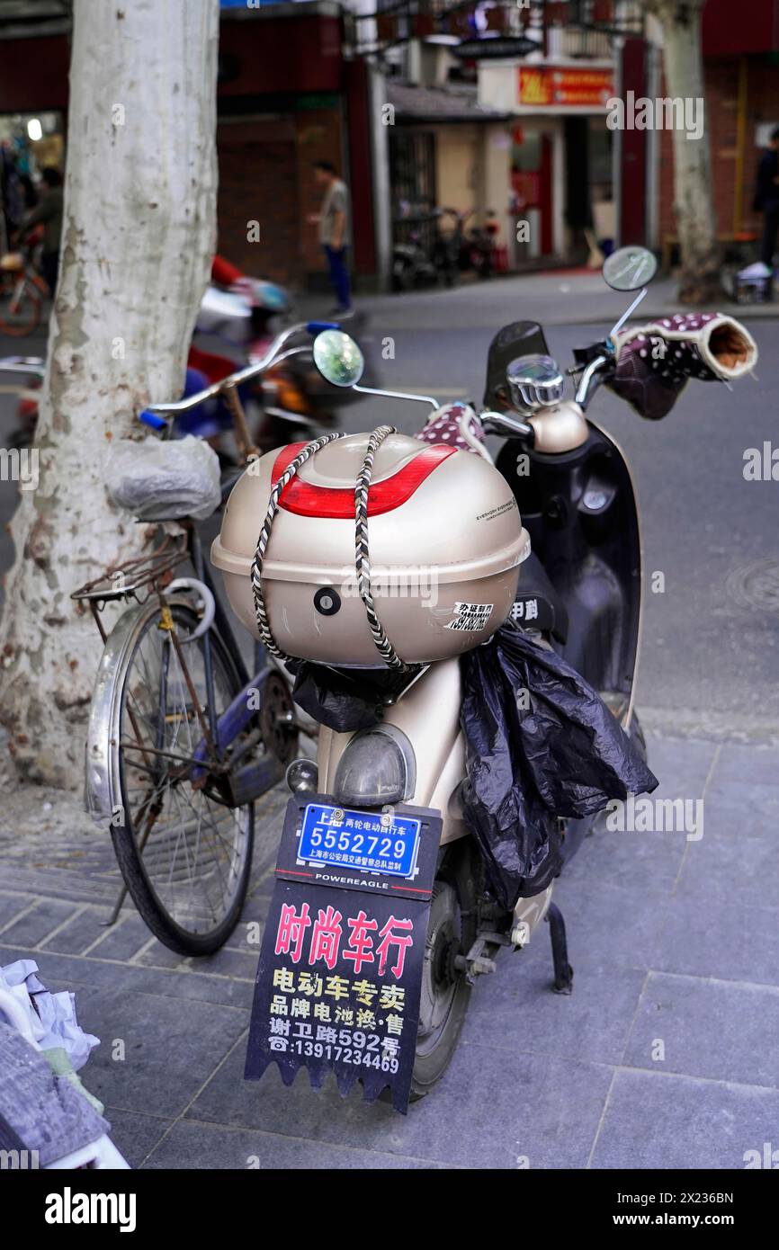 Shanghai, China, Asia, Parked scooter and bicycle on a roadside with ...