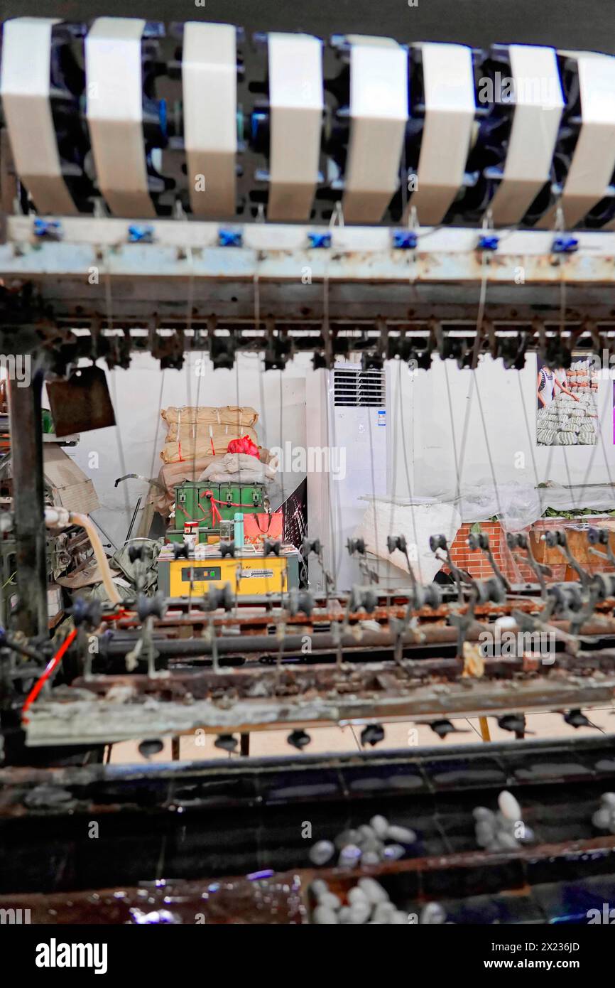 Silk factory Shanghai, close-up of a weaving machine with stripe ...
