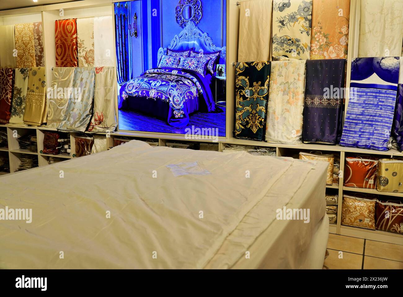 Silk factory Shanghai, A bed surrounded by patterns and fabric panels ...