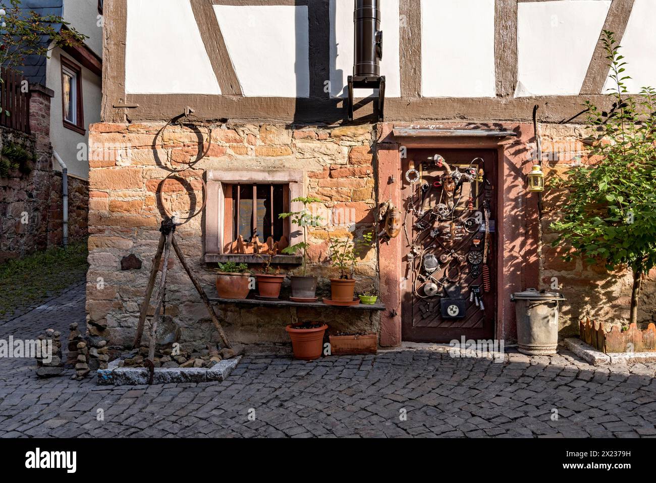 Old half-timbered house, whimsically decorated, stone towers, tripod ...