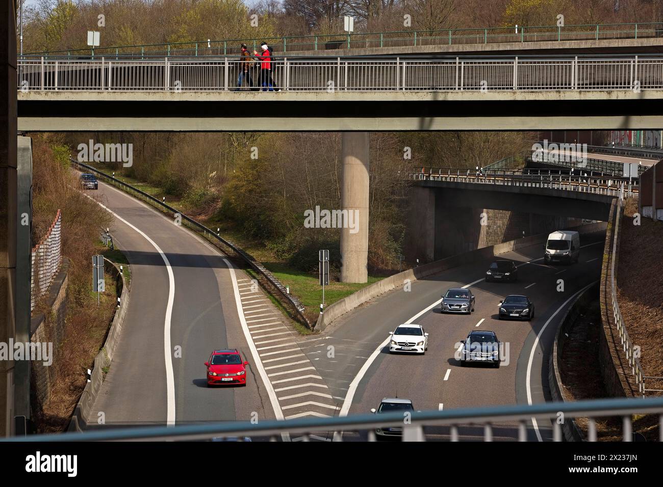 People crossing a pedestrian bridge at Sonnborner Kreuz, motorway ...