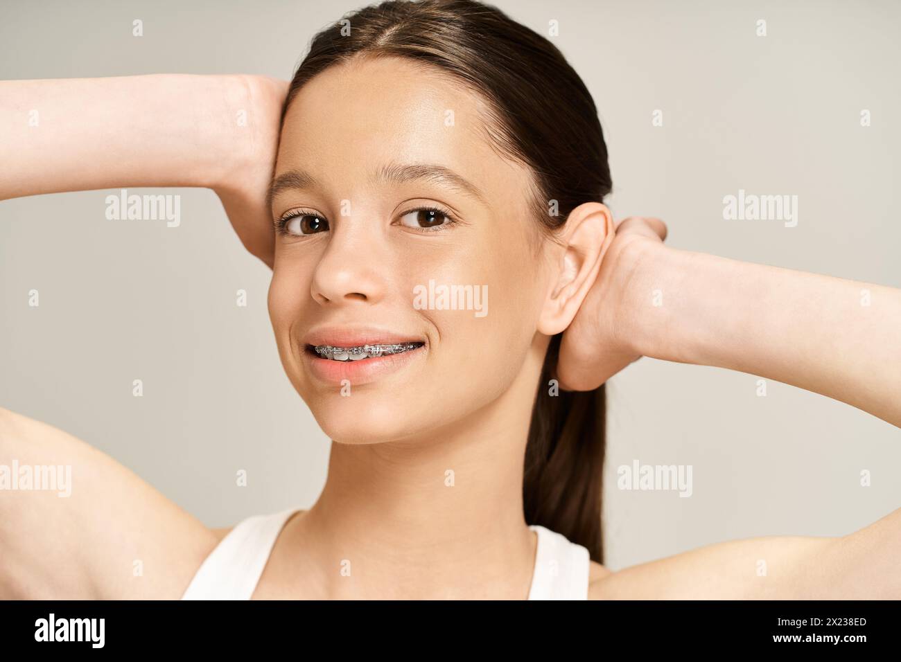 A stylish and vibrant teenage girl exudes joy with a captivating smile ...