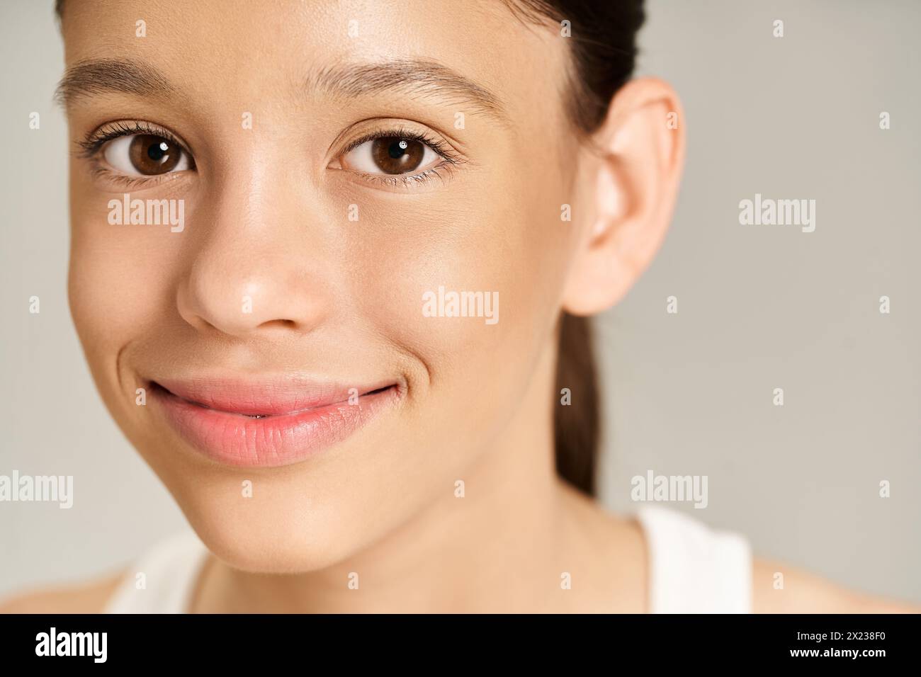 Teenage girl in vibrant attire exudes happiness with a warm smile on ...