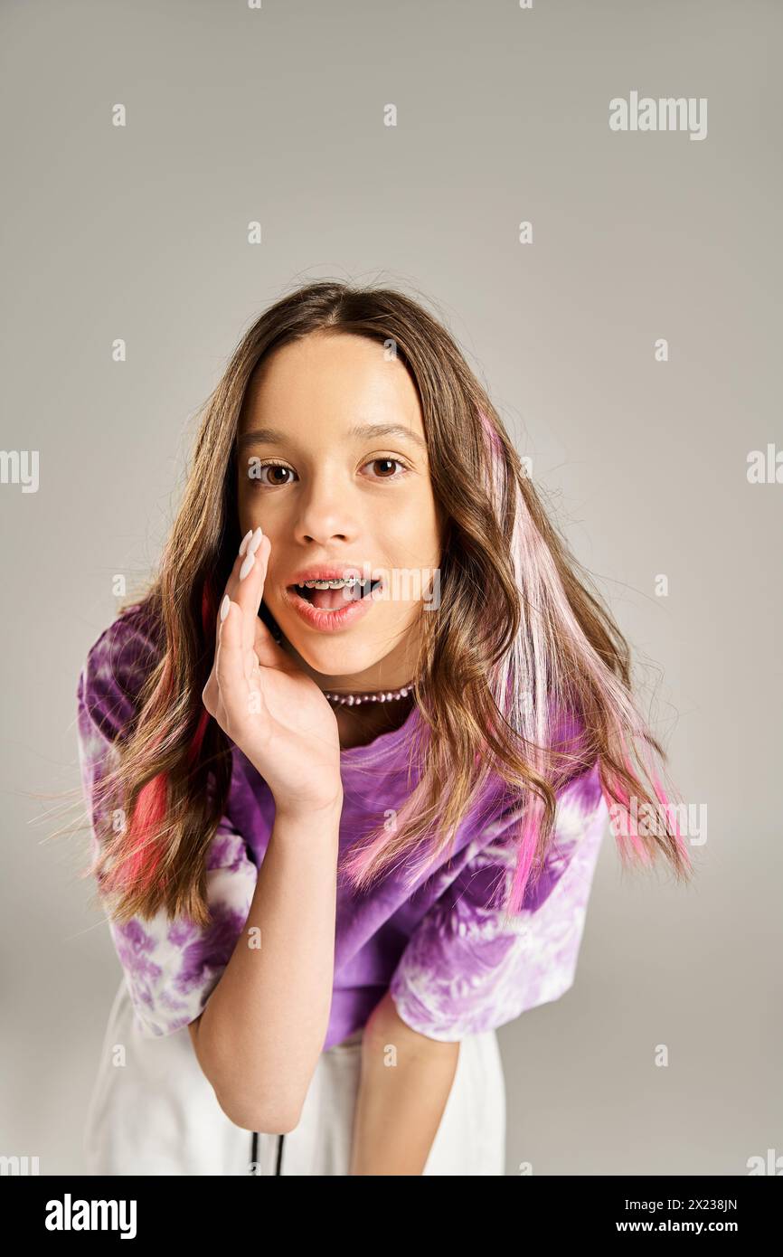 A stylish, good-looking teenage girl poses actively for a picture in ...