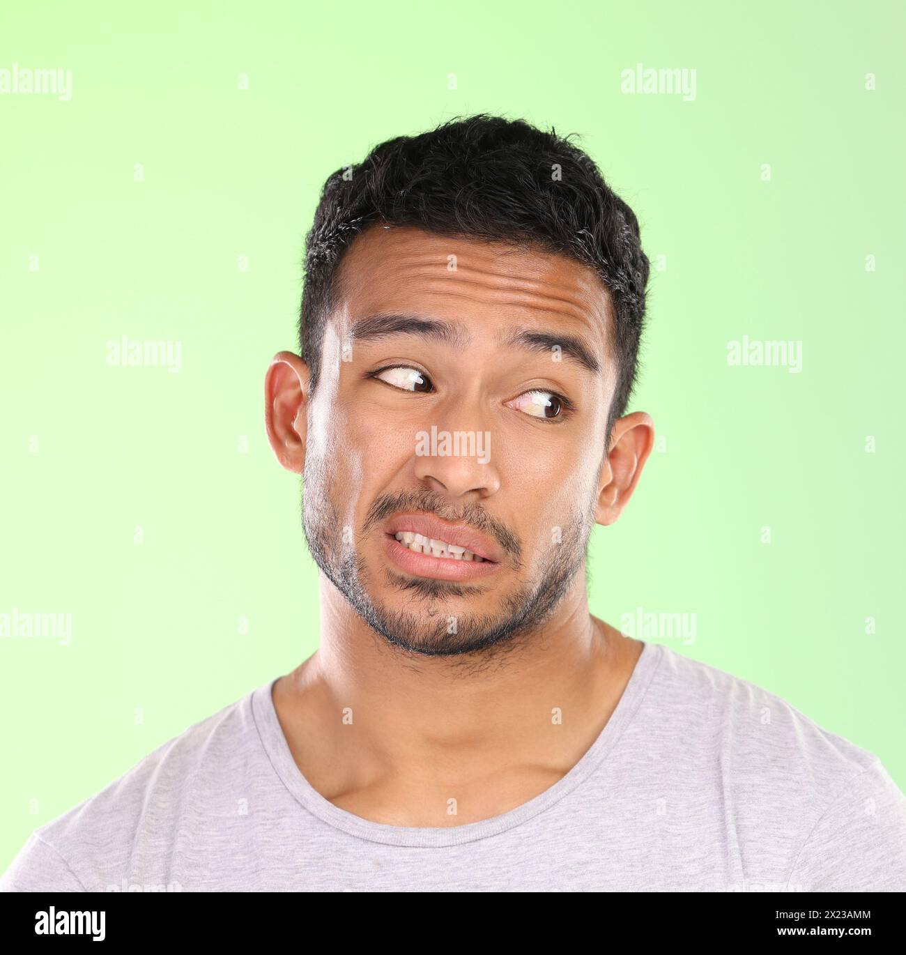 Thinking, crazy and face of man with doubt in studio on pastel green ...