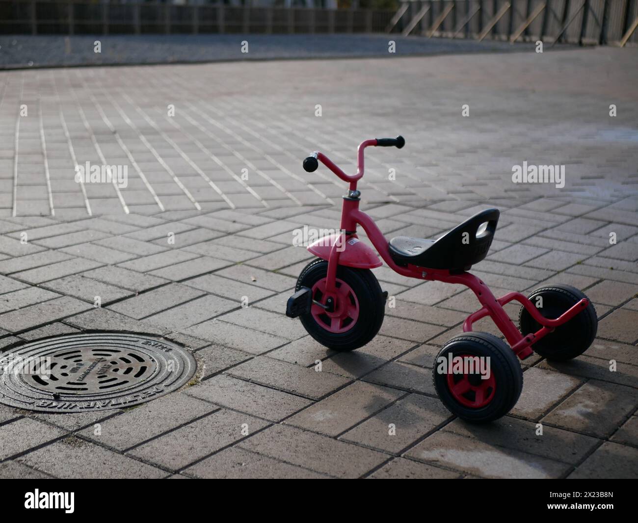 Children's red tricycle Stock Photo - Alamy
