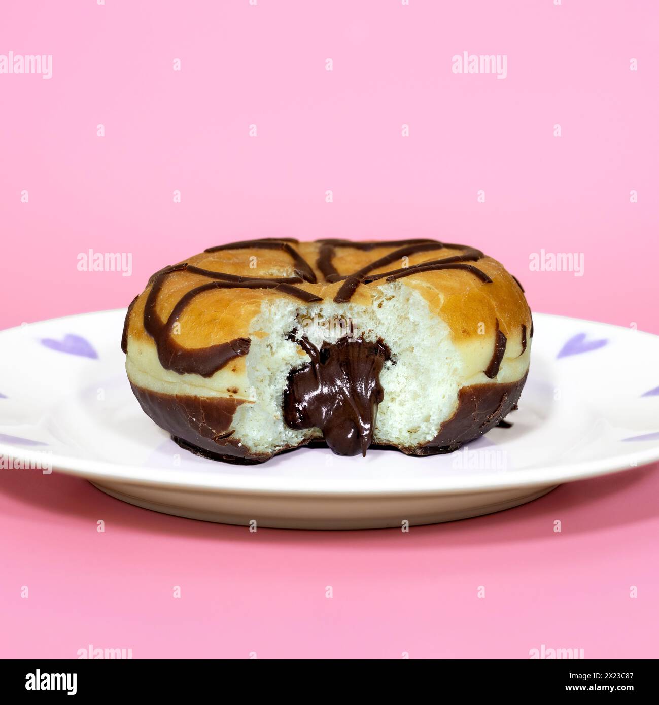 Chocolate filled doughnut with bite taken out, and oozing chocolate ...