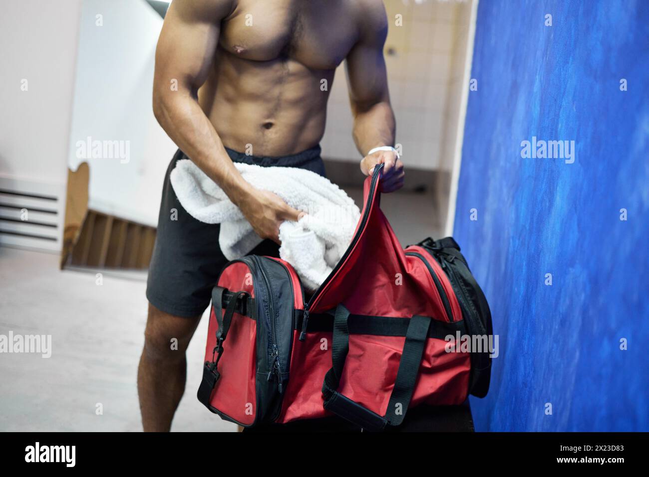 Muscular man, gym and towel with bag in locker room after finishing ...