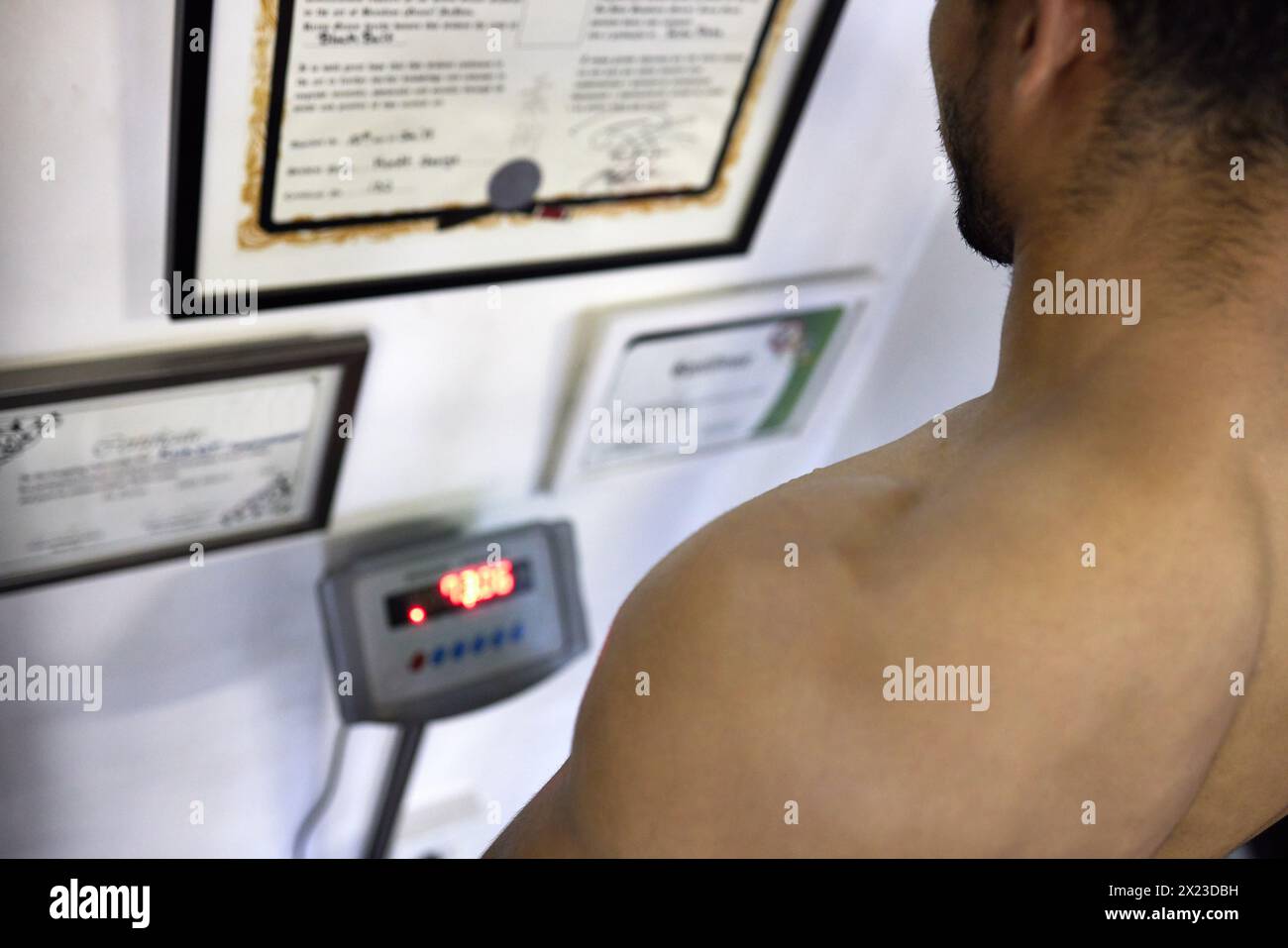 Scale, gym and man checking weight for fitness, health and wellness for ...