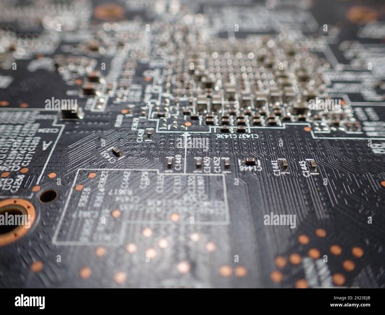 A close-up of a printed circuit board and small components, of which ...