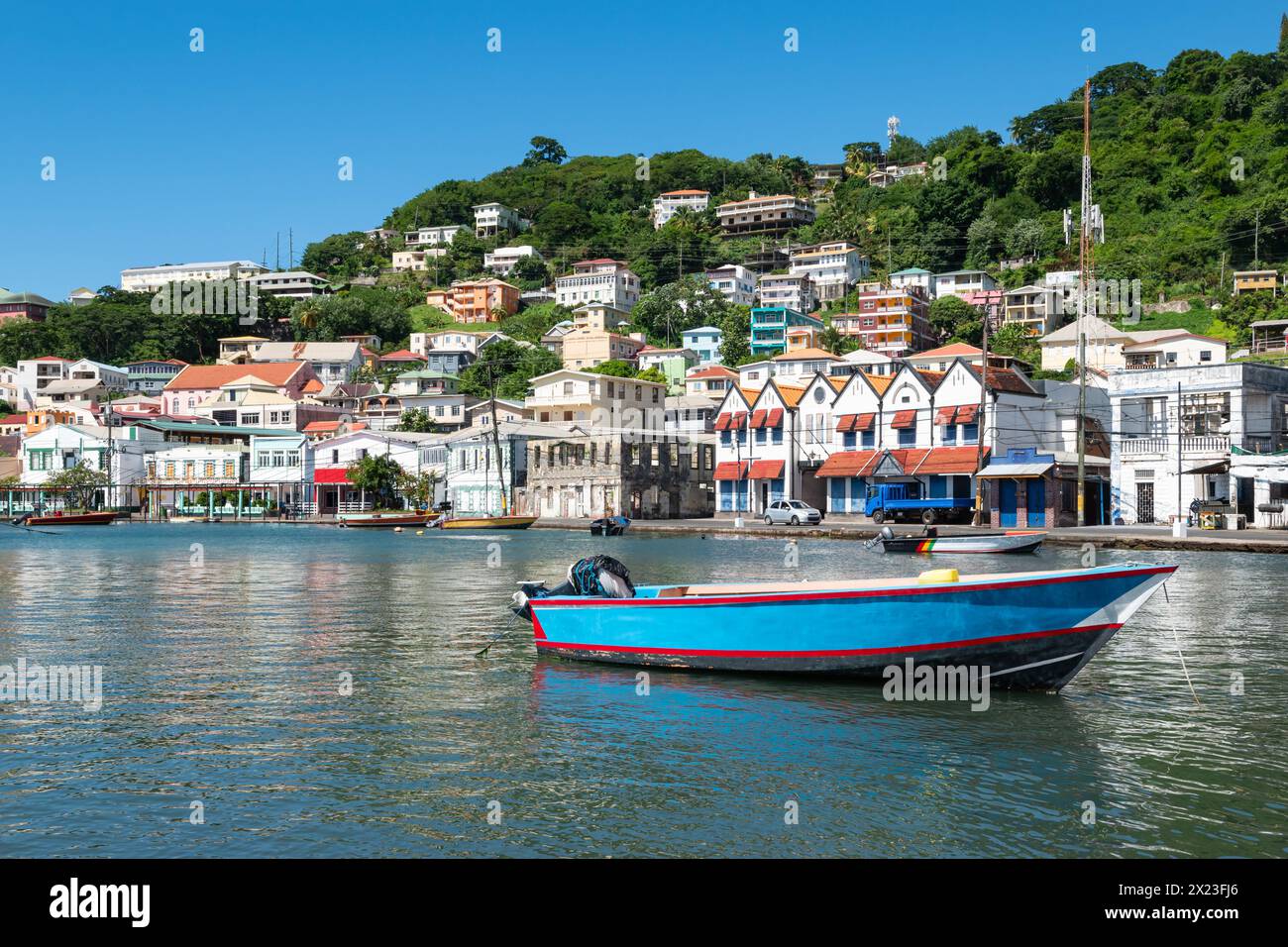 Inner harbor of St George s, Grenada, Caribbean. Blue boat in the bay ...