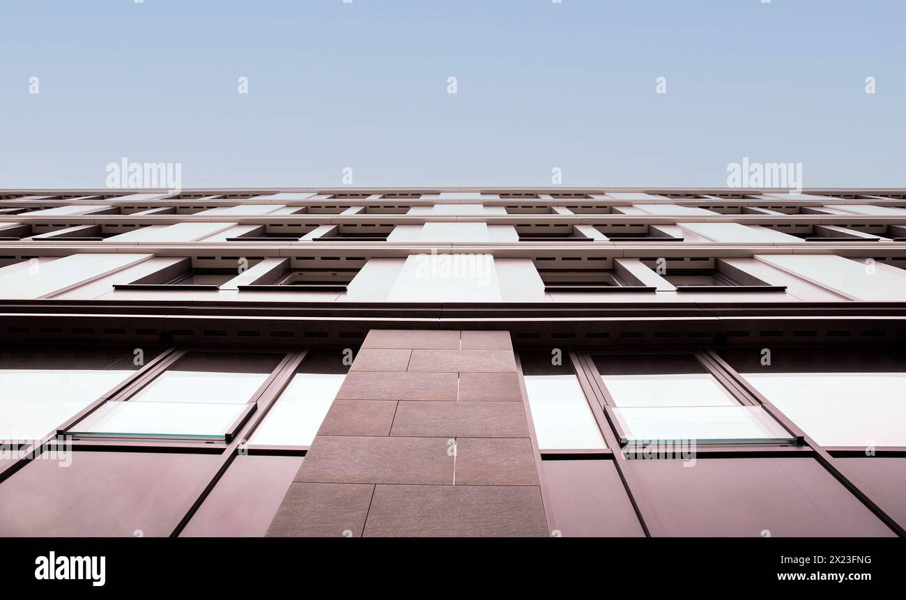 Upward view of a building showcasing geometric window patterns and the ...