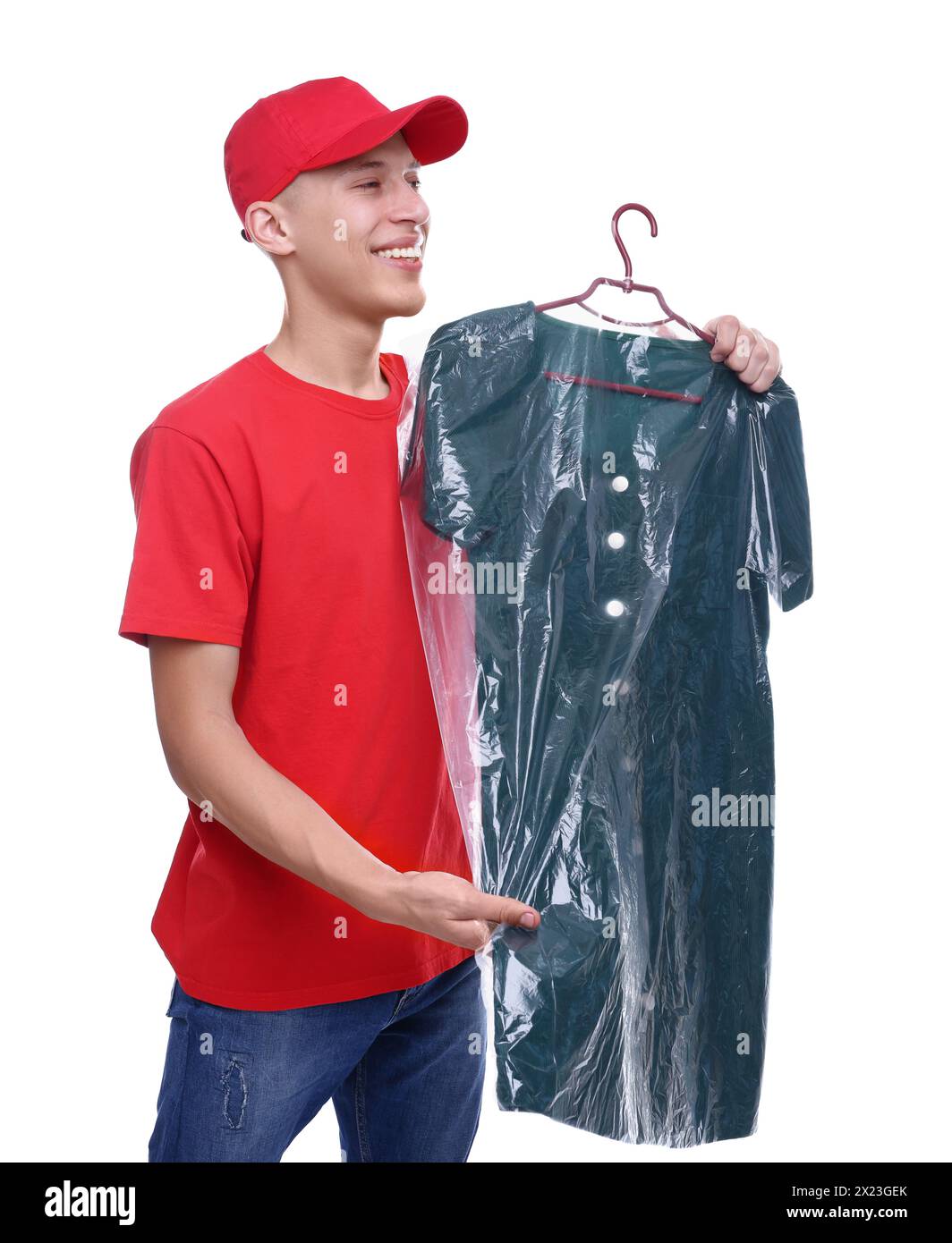 Dry-cleaning delivery. Happy courier holding dress in plastic bag on ...