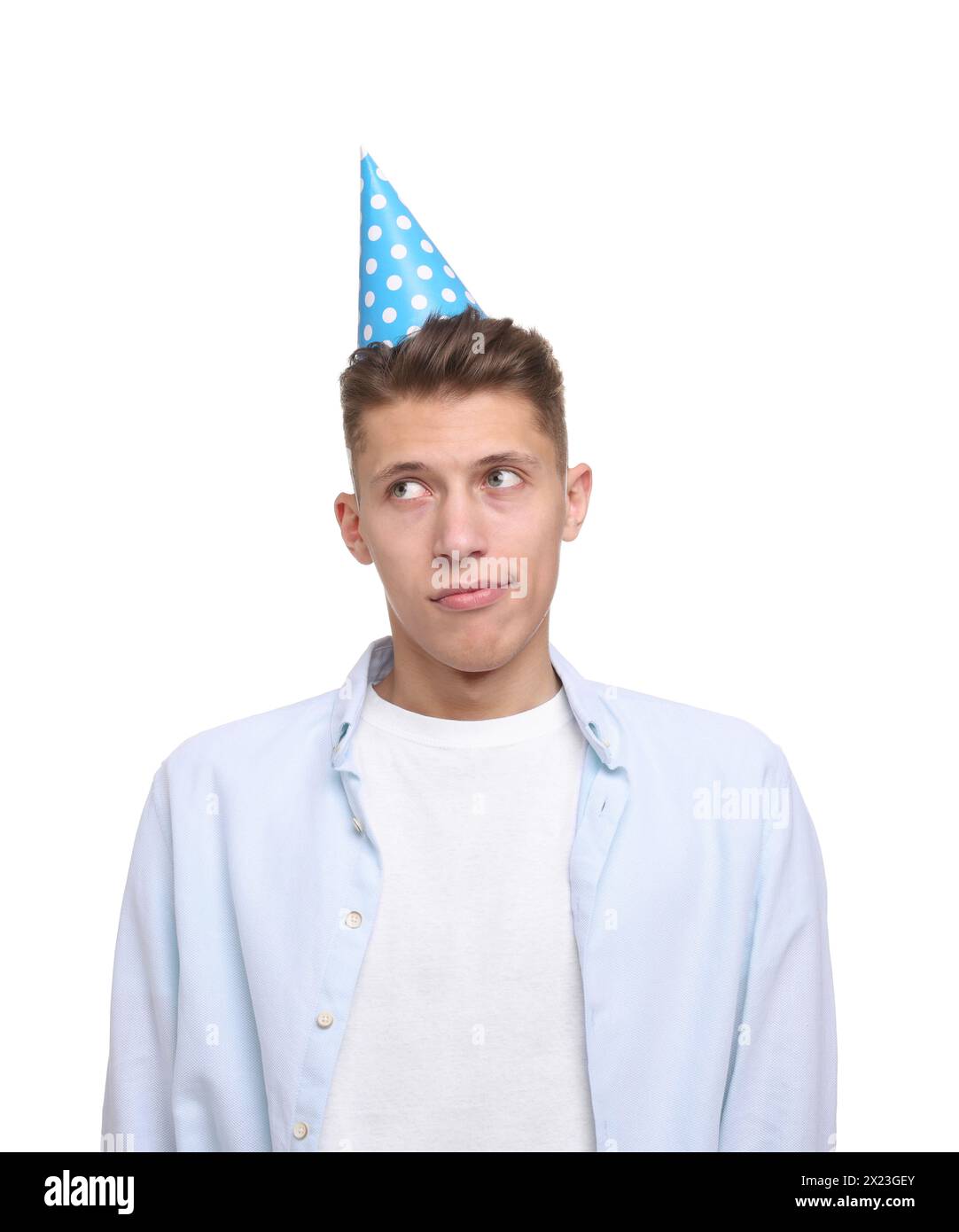 Young man in party hat on white background Stock Photo - Alamy