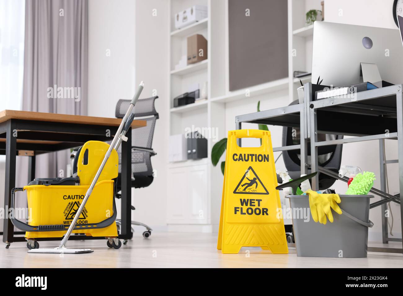 Cleaning service. Mop, wet floor sign and bucket with supplies in ...
