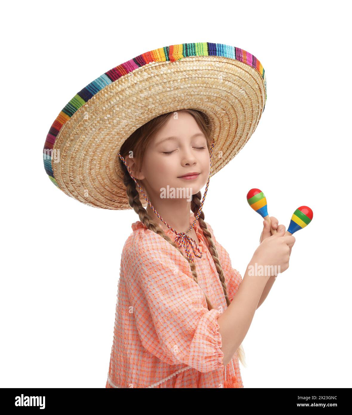 Cute girl in Mexican sombrero hat dancing with maracas on white ...