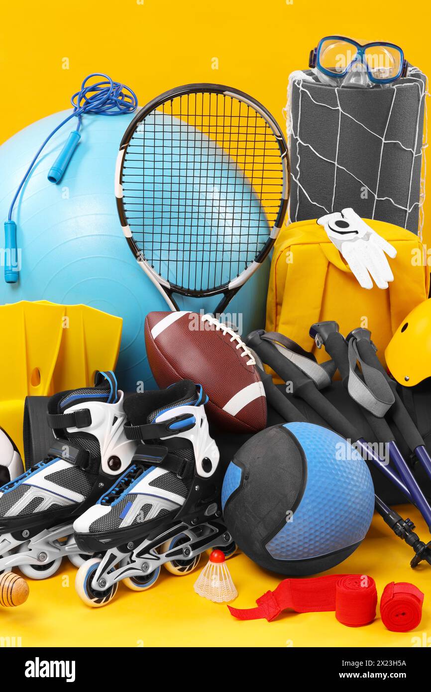 Many different sports equipment on yellow background Stock Photo - Alamy