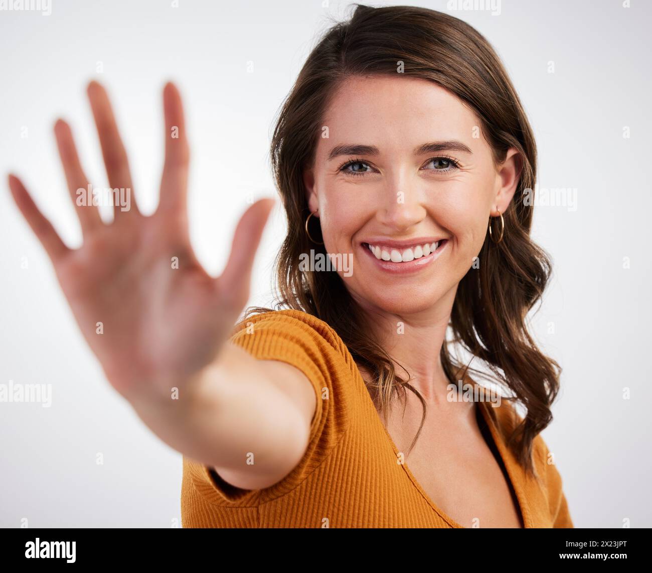 Hand, hello and portrait of happy woman in studio for volunteering ...
