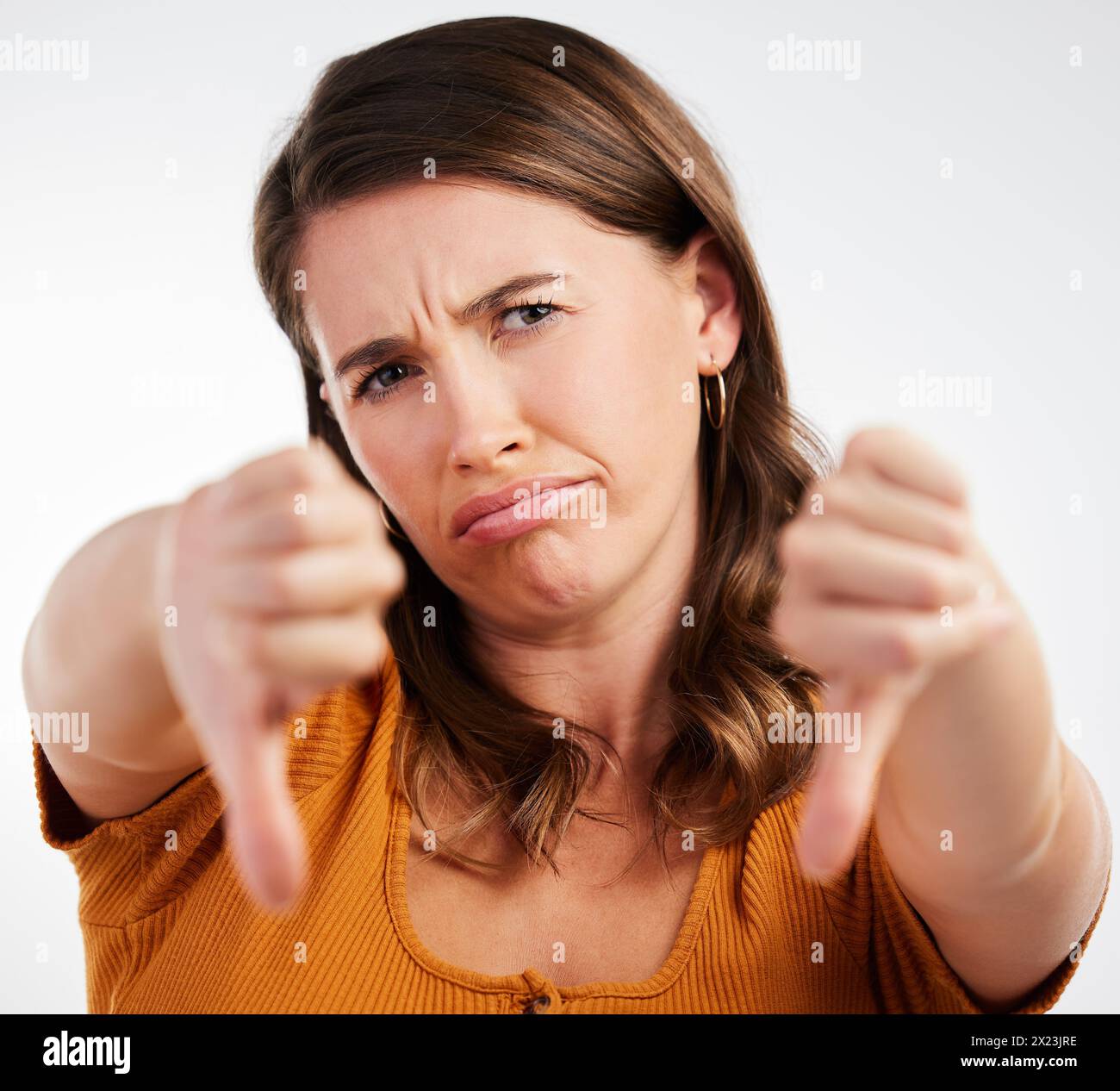 Portrait, frown and woman with thumbs down rejection for studio vote ...