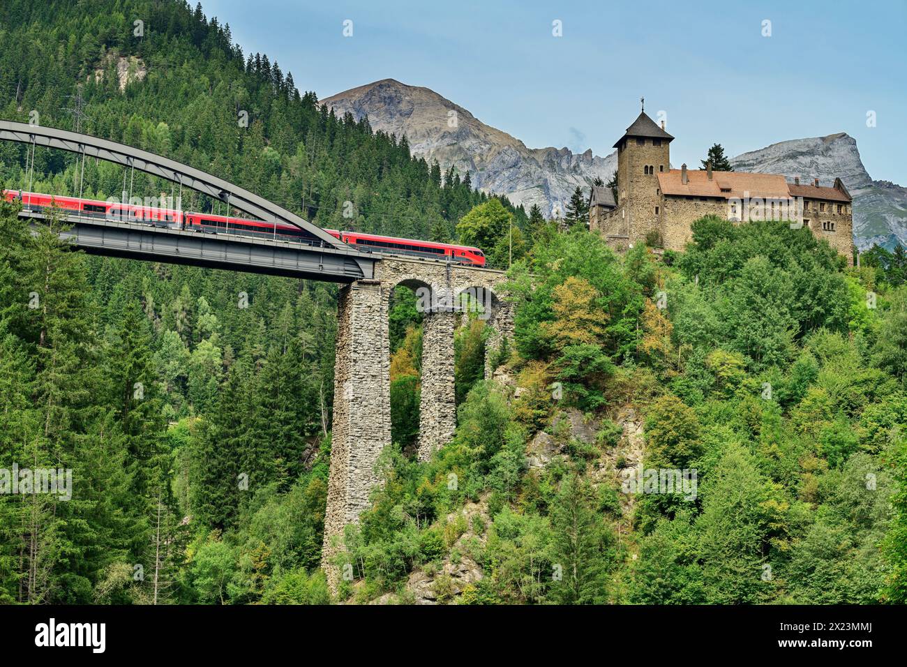 Train passes over Trisanna Bridge, Wiesberg Castle in the background ...