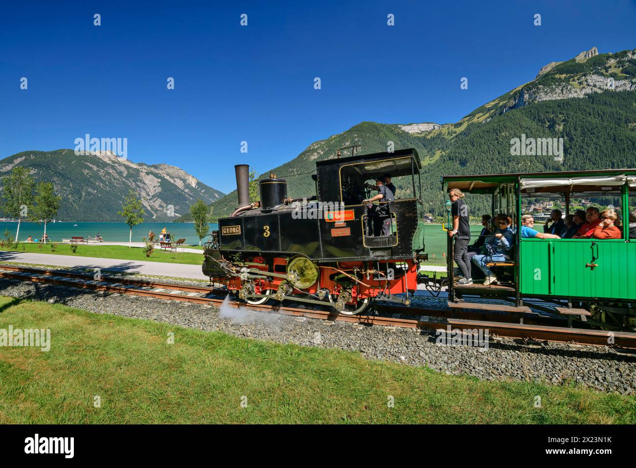 Steam locomotive of the Achenseebahn runs along the Achensee, Karwendel ...