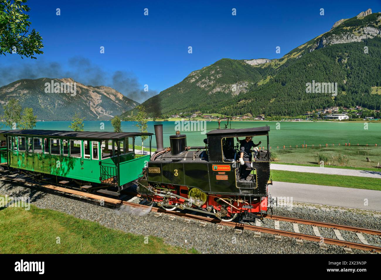 Steam locomotive of the Achenseebahn runs along the Achensee, Karwendel ...
