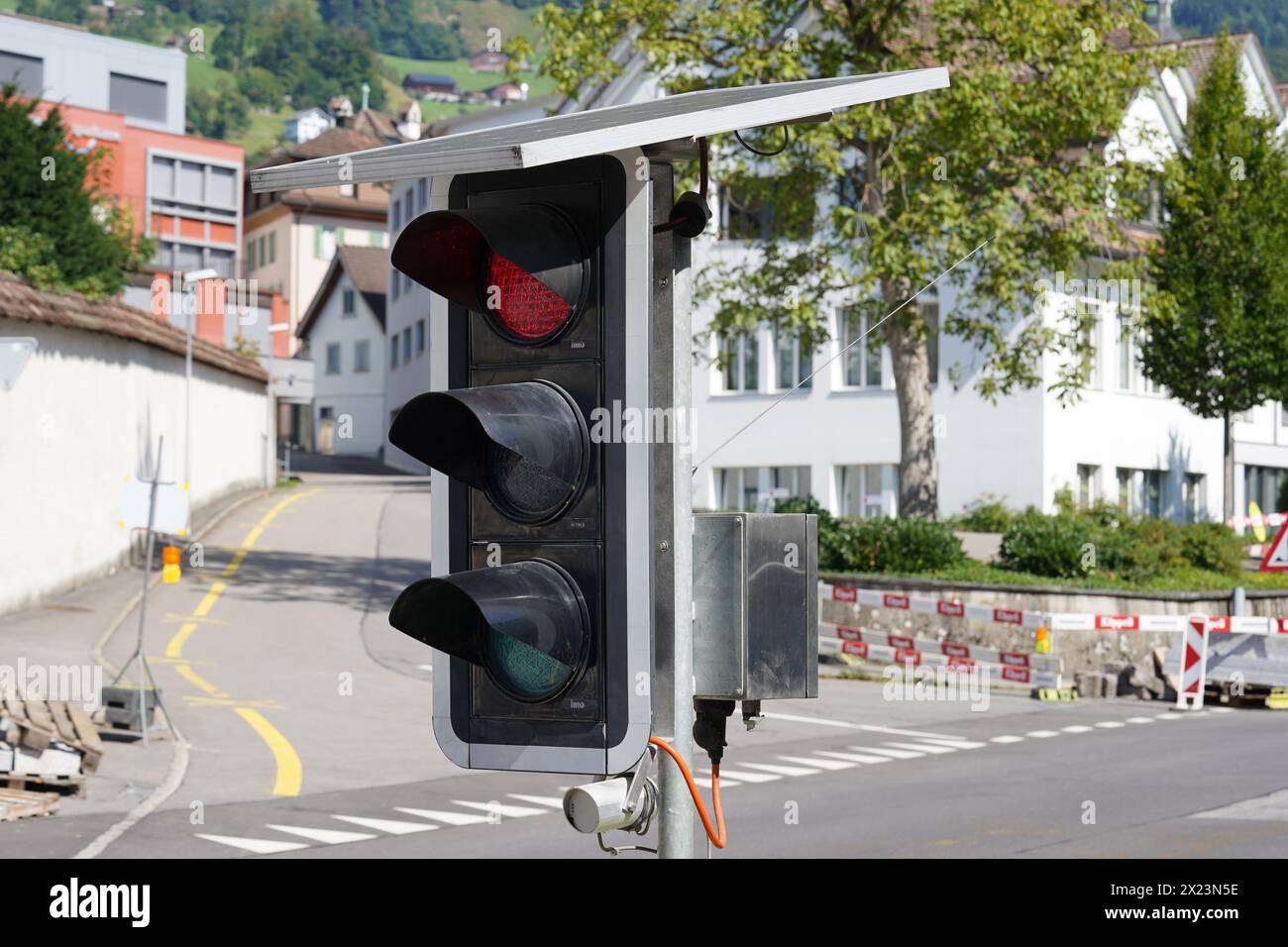 Portable traffic light powered by solar panels situated on the road to ...