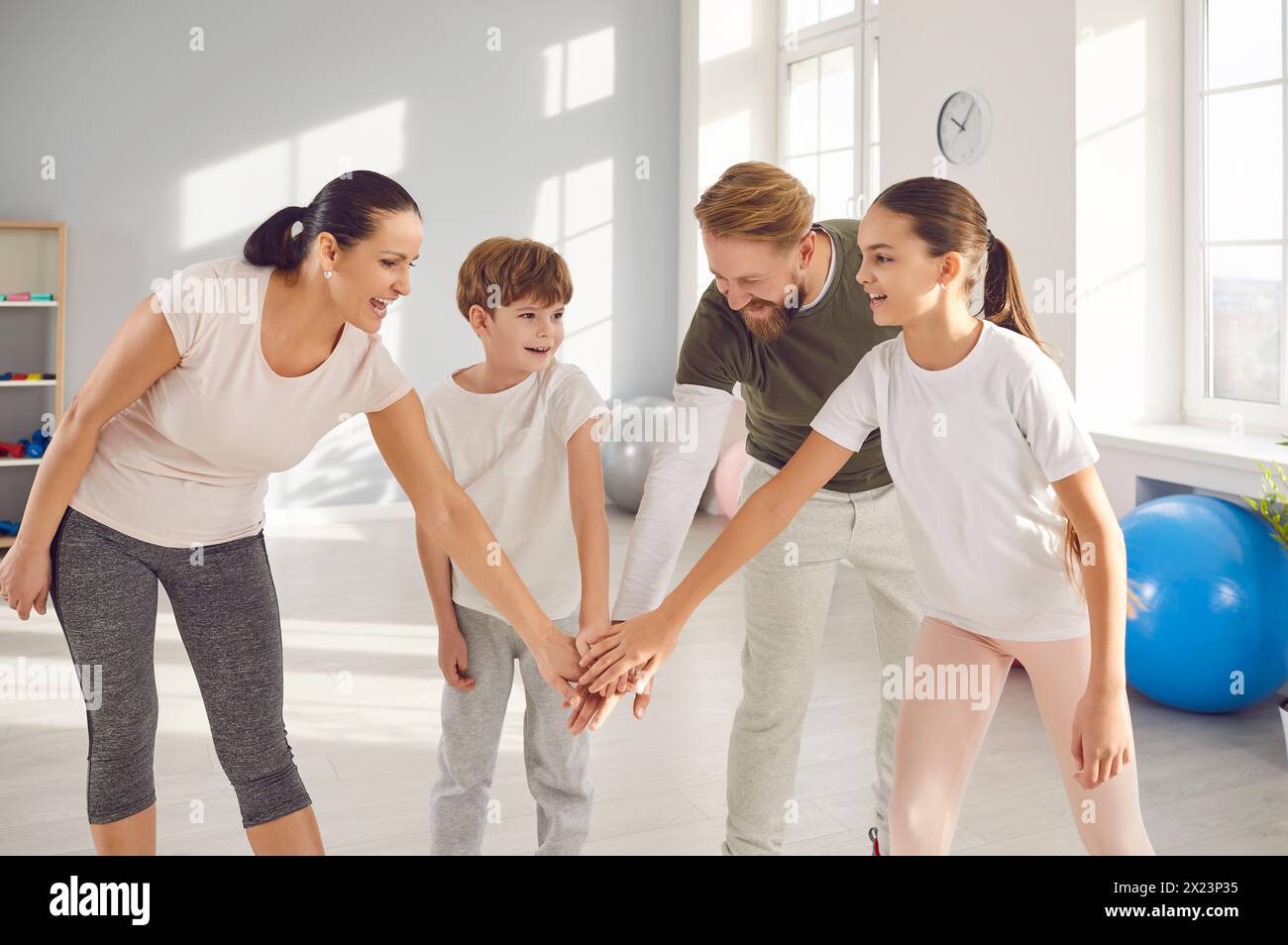 Happy parents and children having fun during a family fitness workout ...