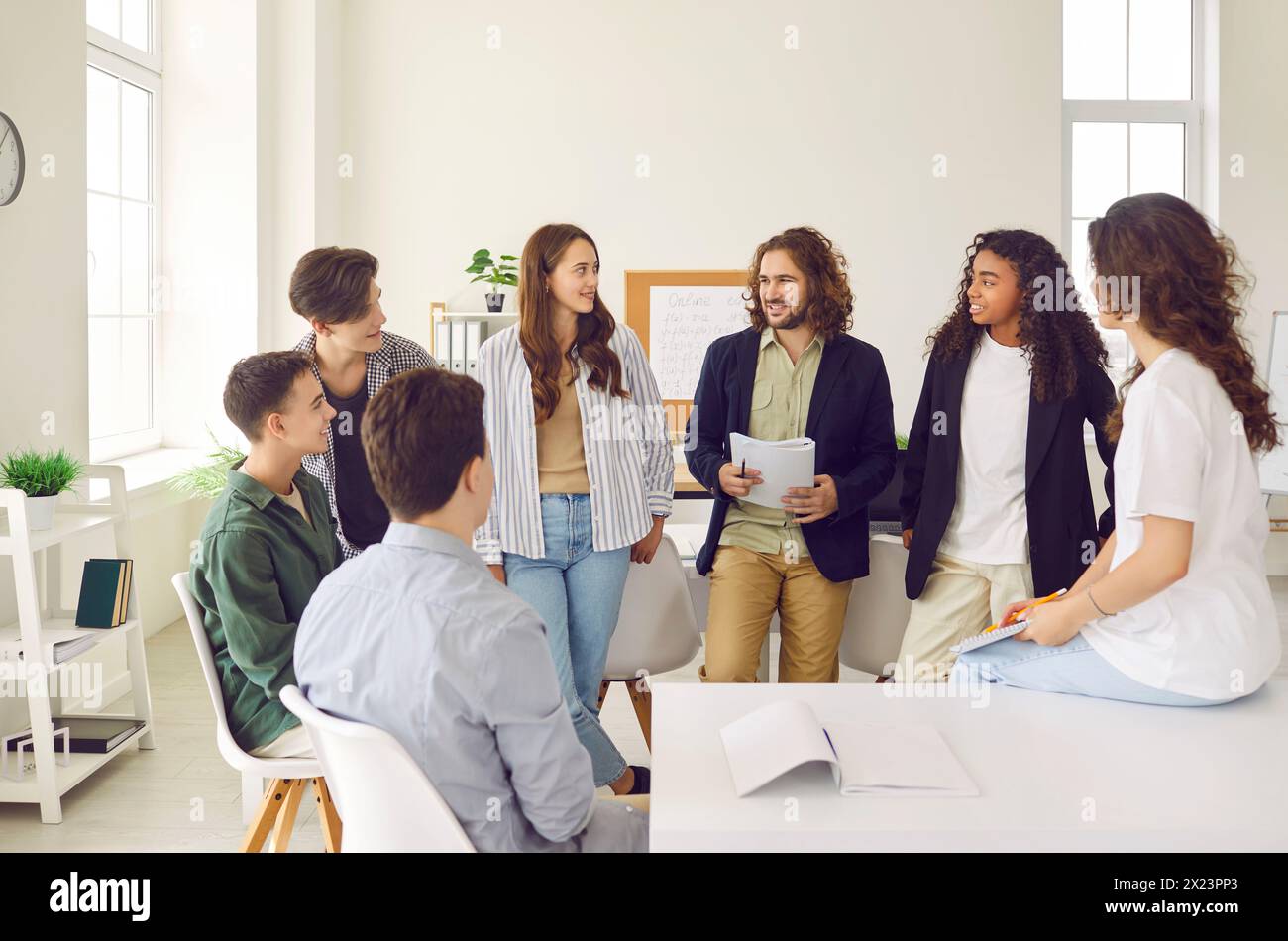 Group of diverse teenage school students and their teacher having ...