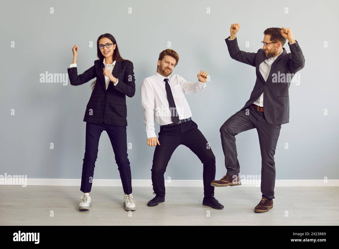 Three business people dancing and celebrate success in business ...