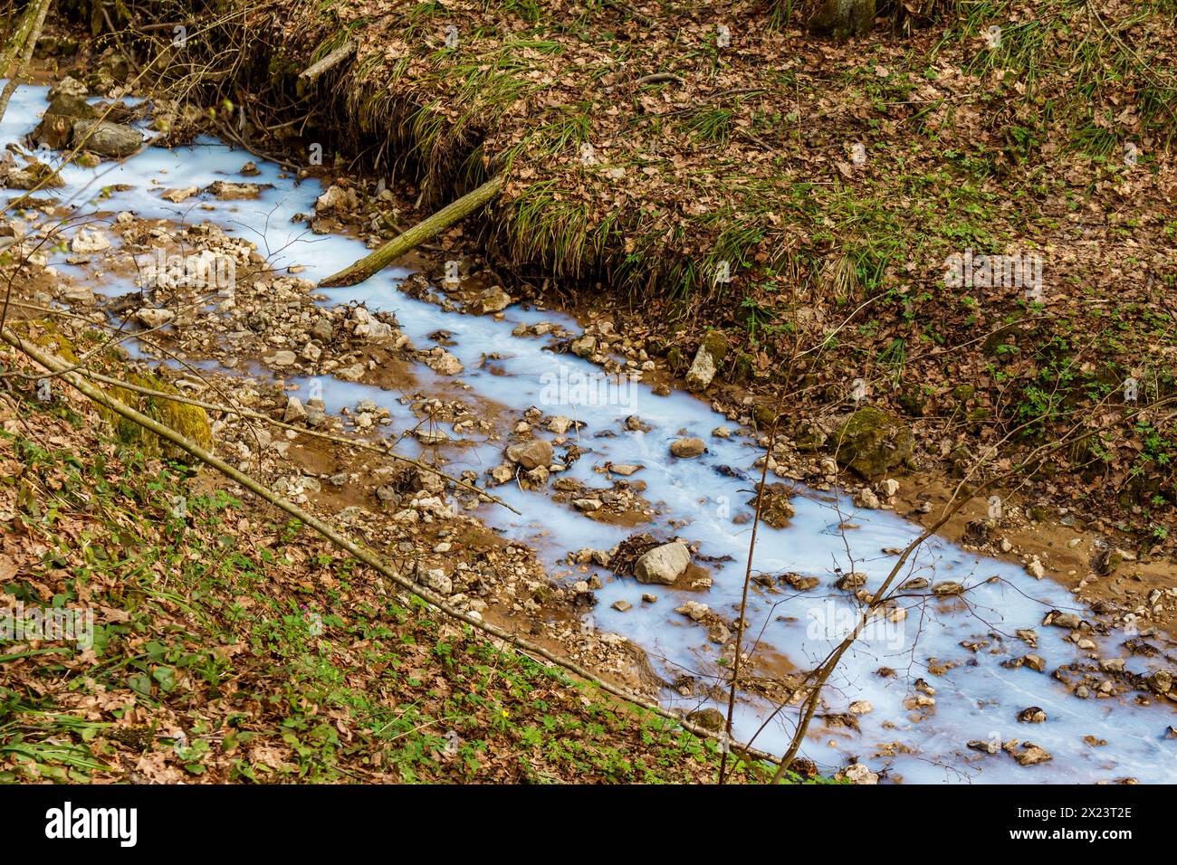 A stream in a ravine of white and blue color, environmental pollution ...