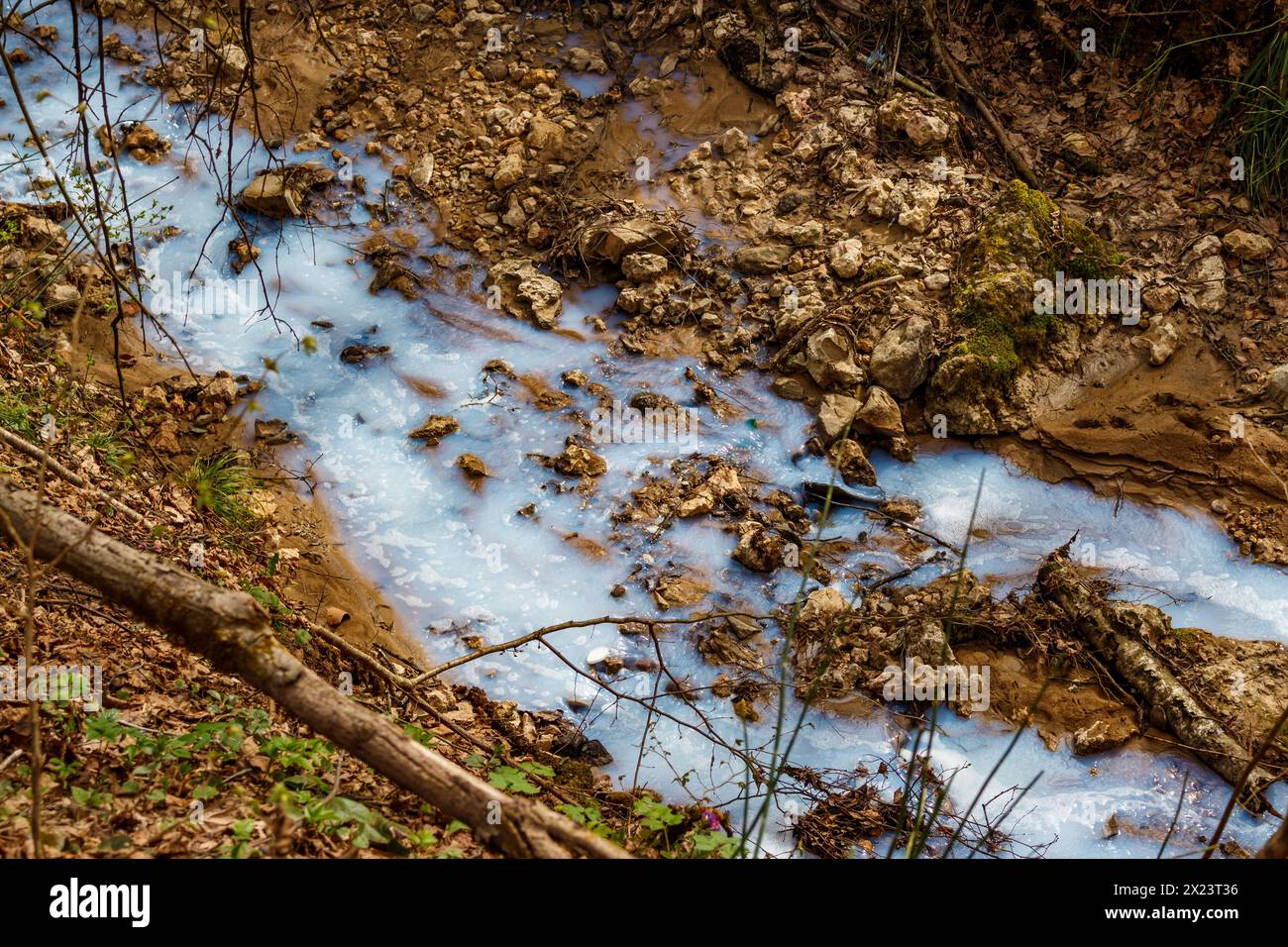 A stream in a ravine of white and blue color, environmental pollution ...