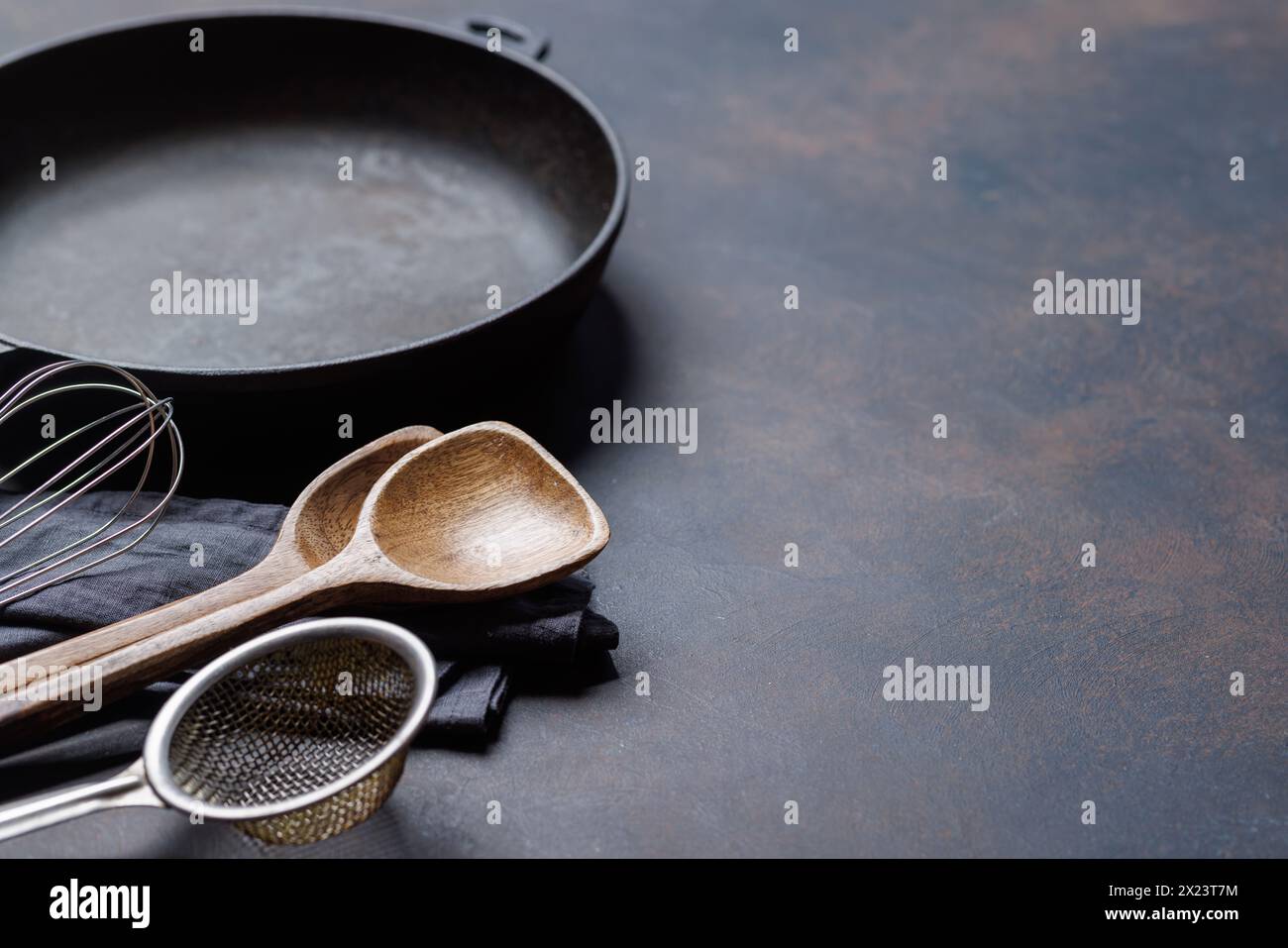 Culinary essentials: Diverse cooking utensils on stone table. With copy ...