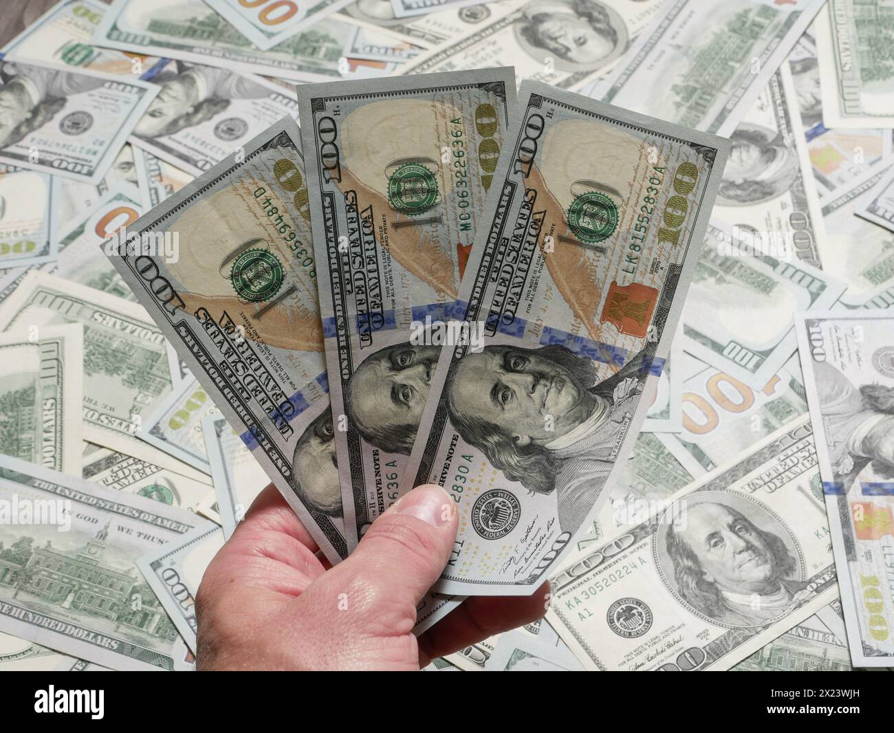 Hand holding banknote bundle of US dollar in hand Stock Photo - Alamy